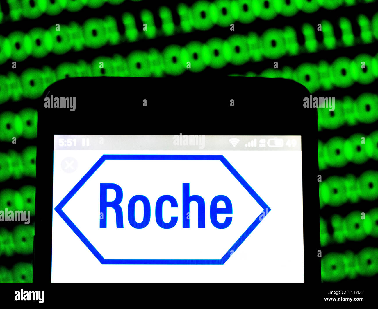 In this photo illustration a Roche Holding AG logo seen displayed on a ...
