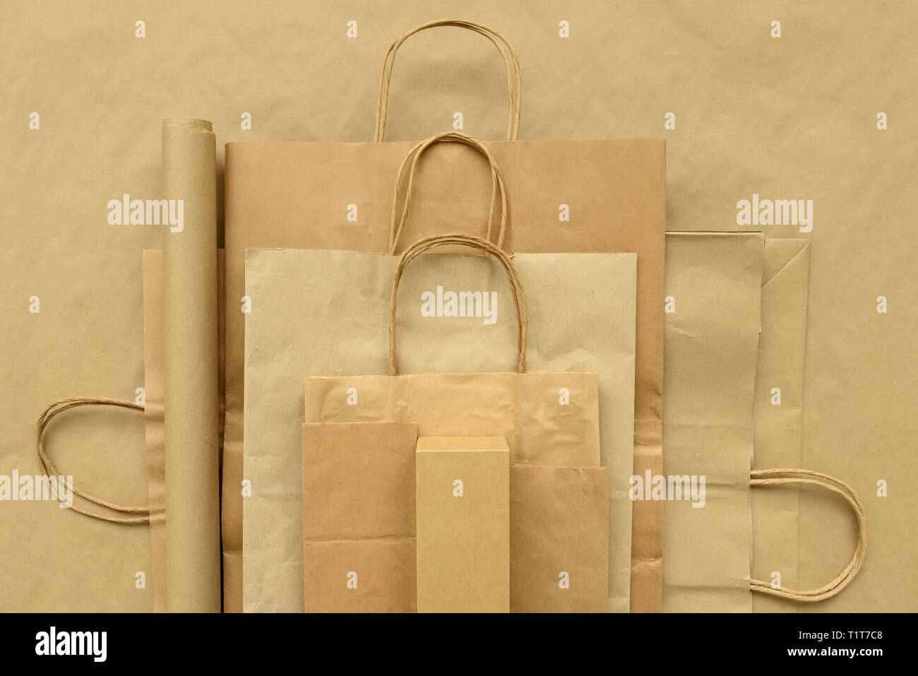 Paper packages on brown background. Copy space. Top view. Eco and save ...