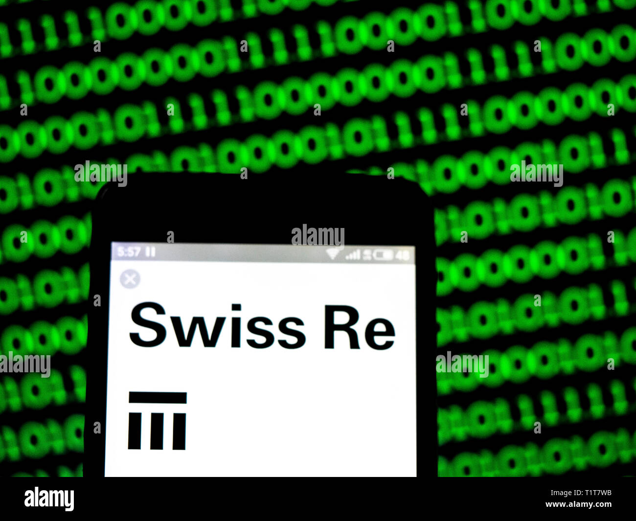 In this photo illustration a Swiss Re logo seen displayed on a smart ...