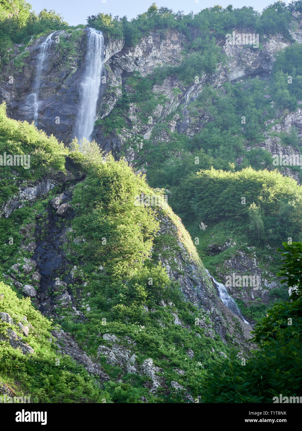 Views of the green mountains with rocks and the highest waterfall Stock ...