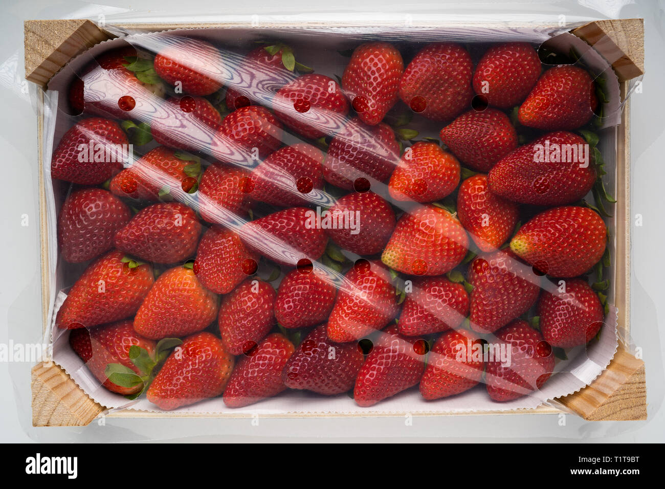 Strawberry in white wooden package isolated Stock Photo - Alamy