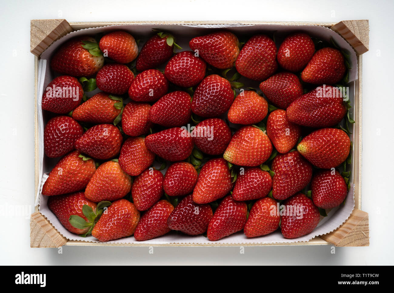 Strawberry in white wooden package isolated Stock Photo - Alamy