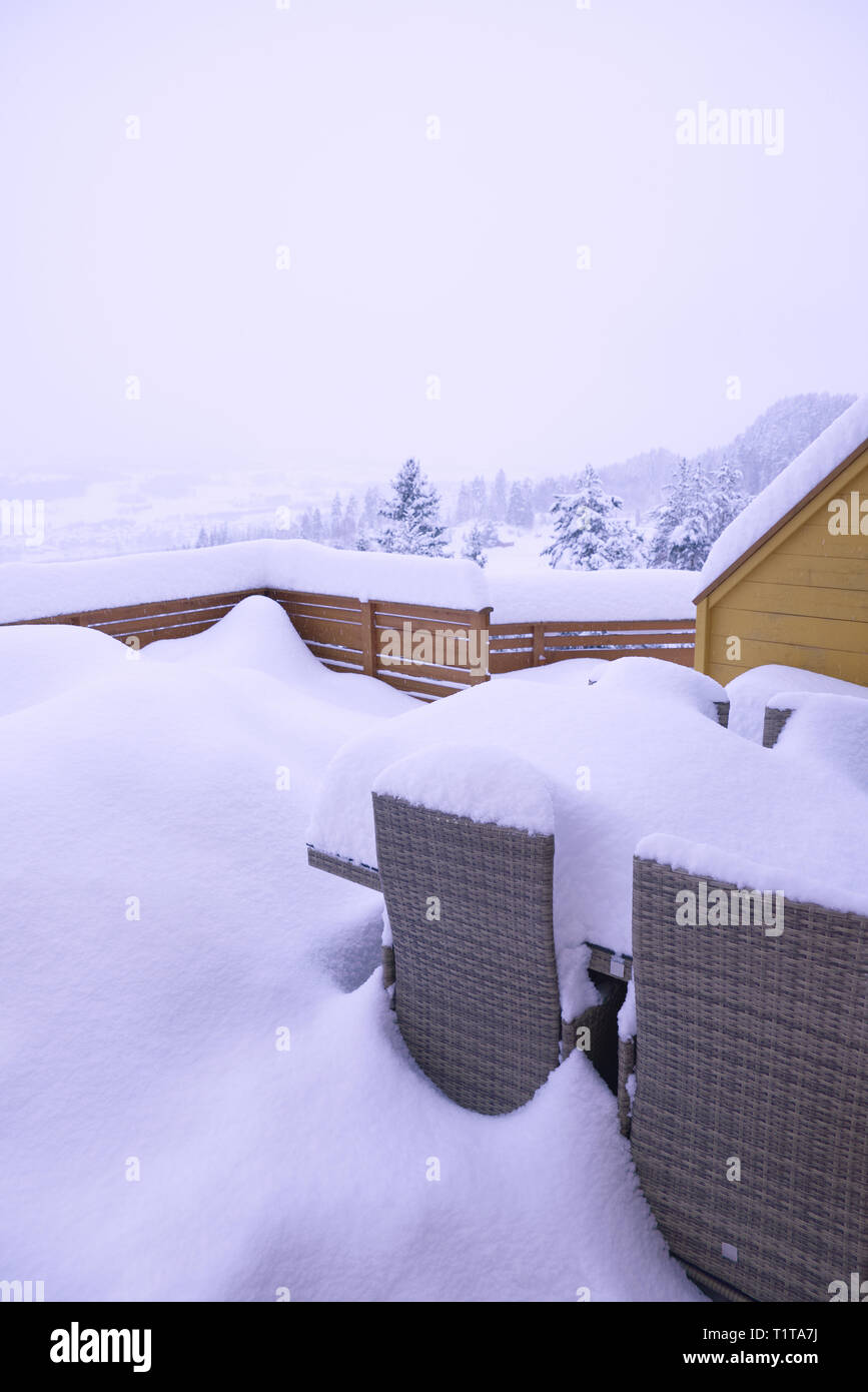 Snow covered deck with furnitures in Norway Stock Photo - Alamy