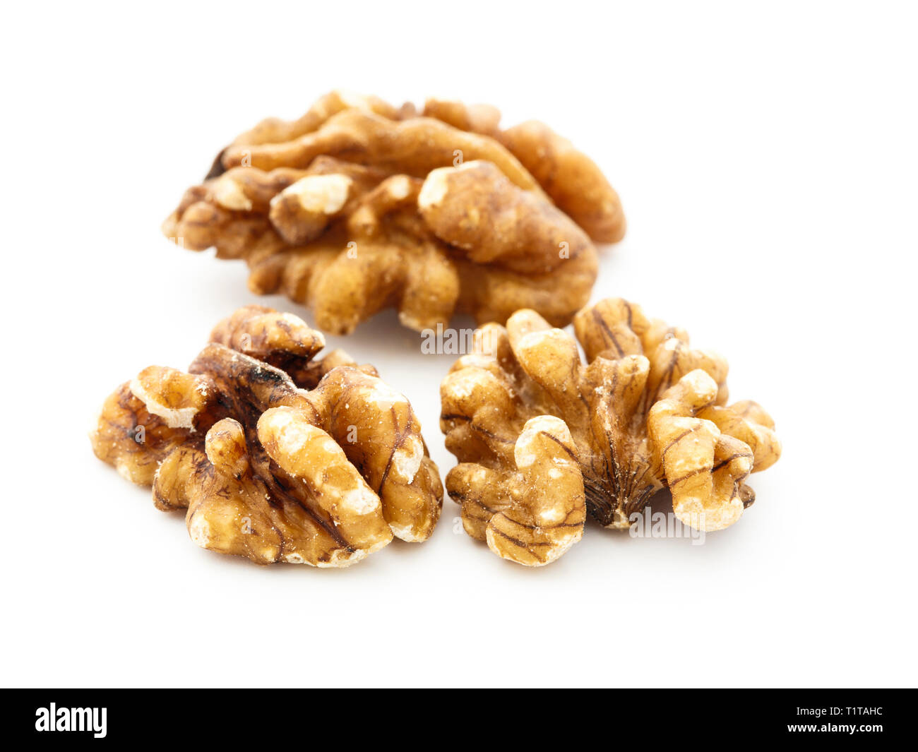Three Walnut halves of Walnuts shelled nuts isolated on a white ...