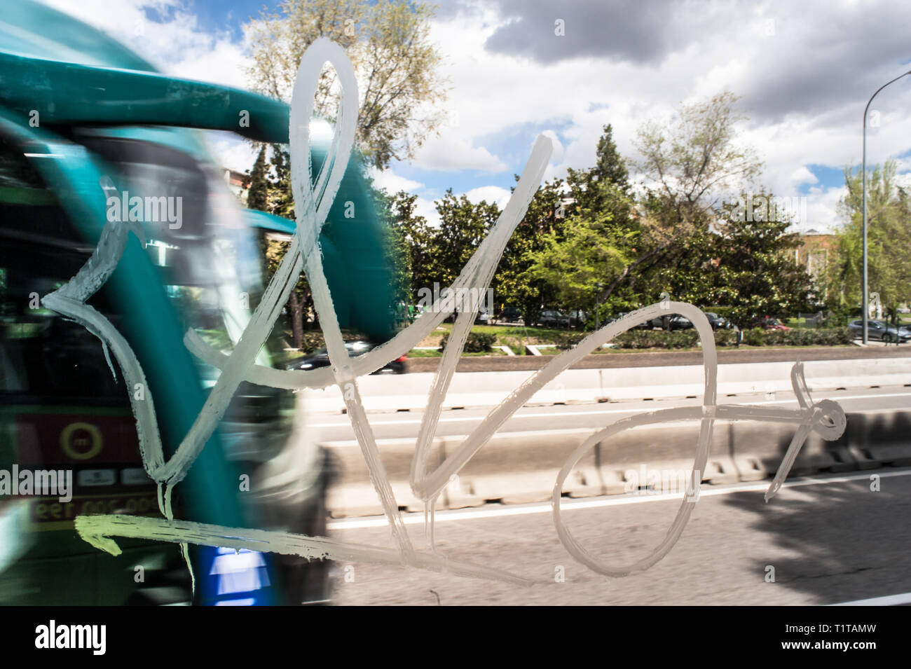 Graffiti tag on a bus window, Madrid, Spain Stock Photo - Alamy