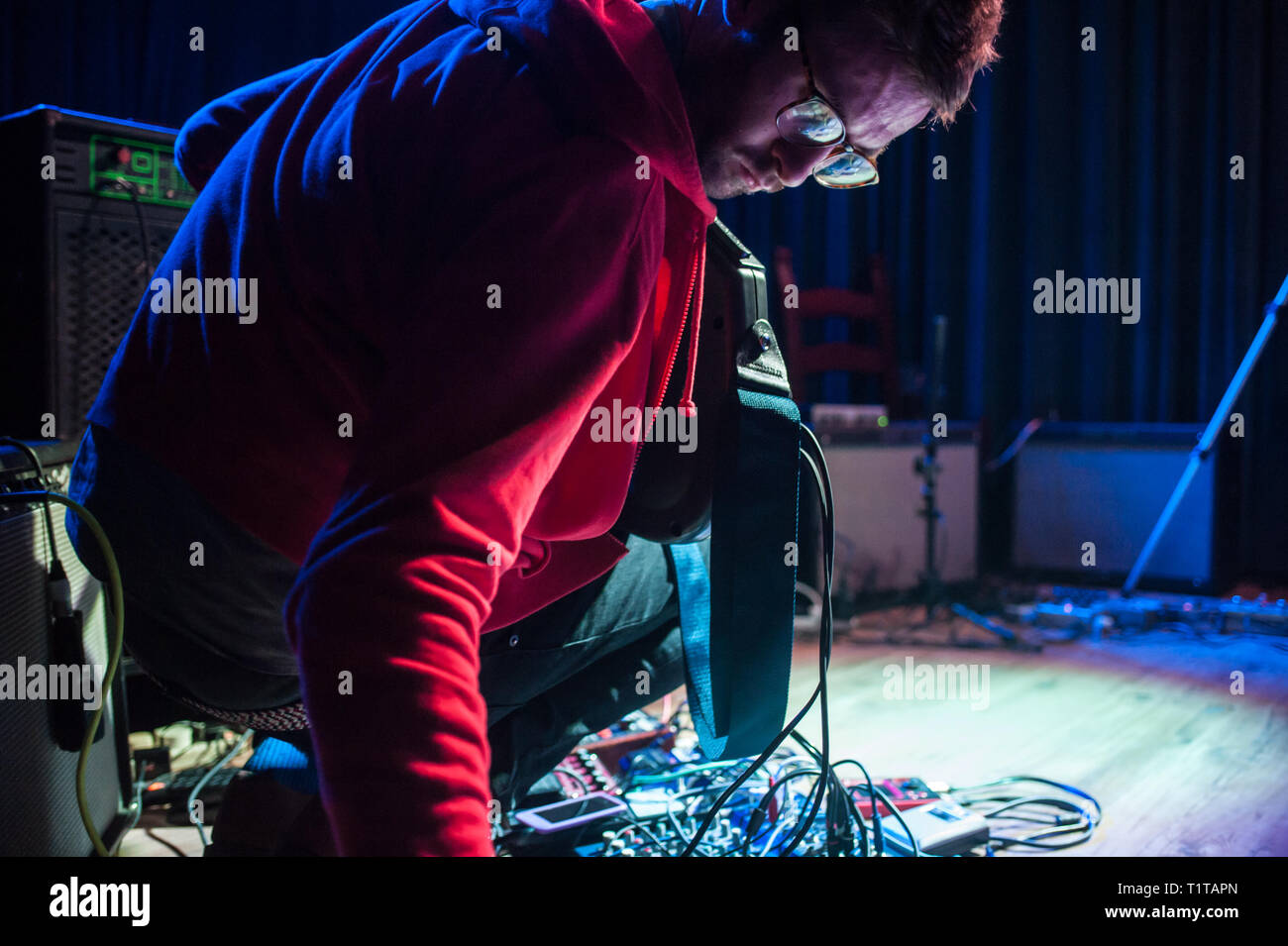 A man plays experimental music with a guitar and a multitude of effects ...
