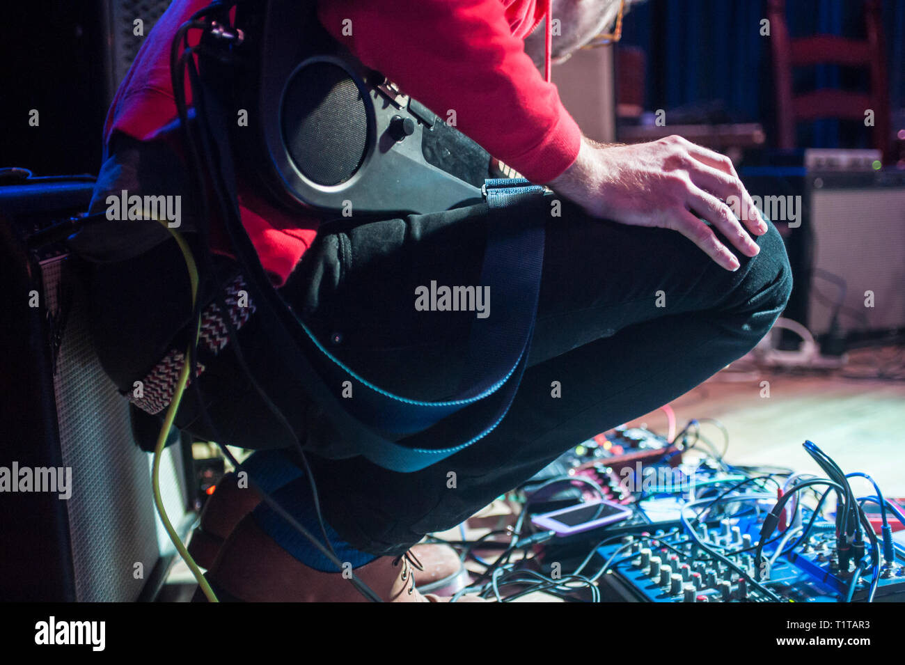 A man plays experimental music with a guitar and a multitude of effects ...
