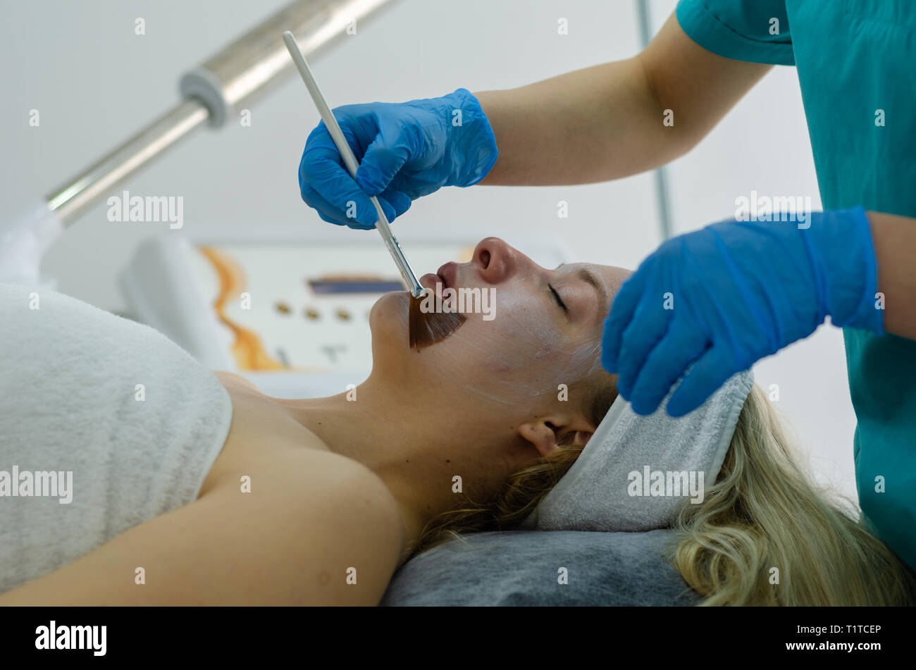 Beautiful woman having a facial cosmetic scrub treatment. Anti-aging ...