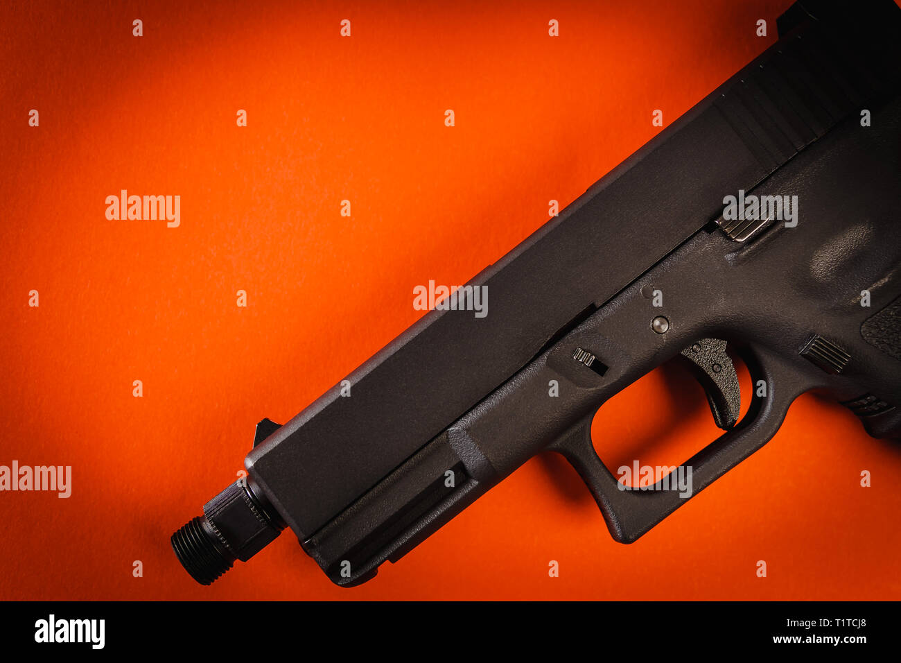 one black handgun on intense red background Stock Photo - Alamy