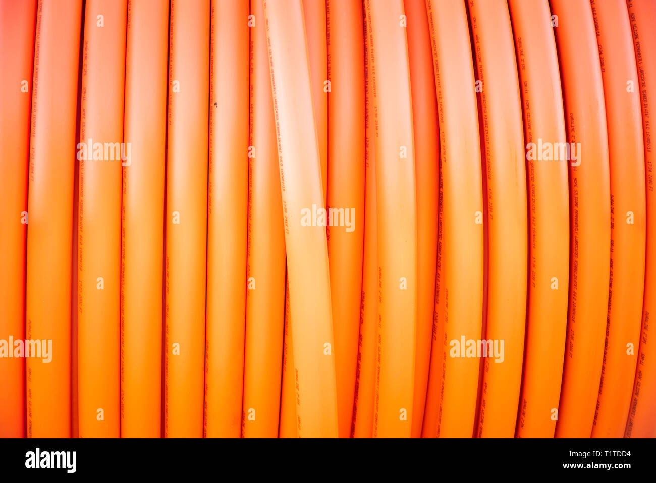 A roll of orange protective plastic insulation for a high-tension wire ...