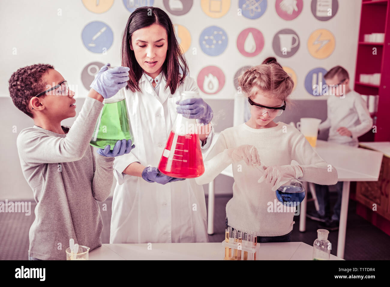 Children playing with test tubs filled with colored reagents Stock ...