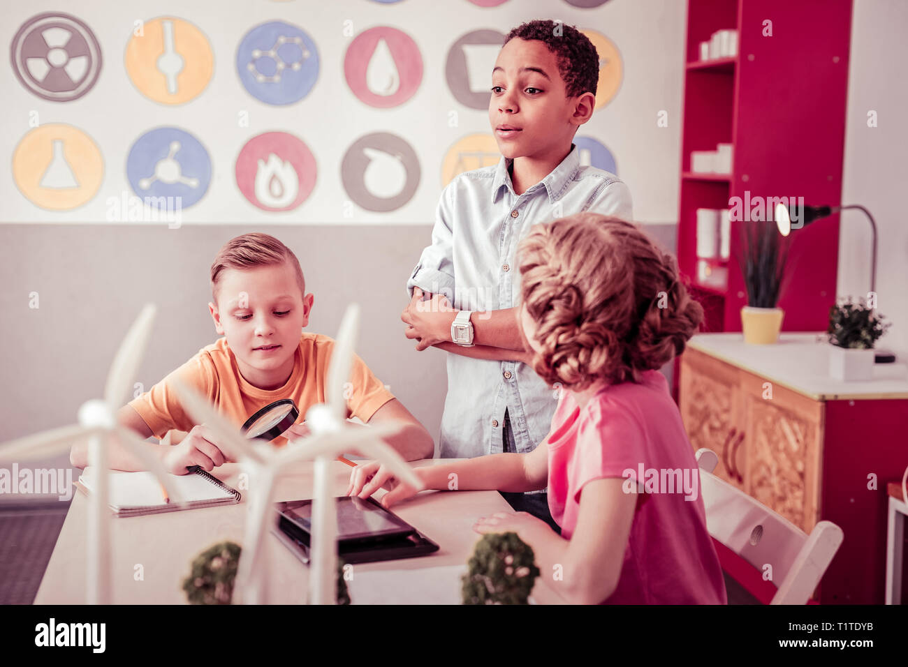 Little students sitting in class room and playing Stock Photo - Alamy