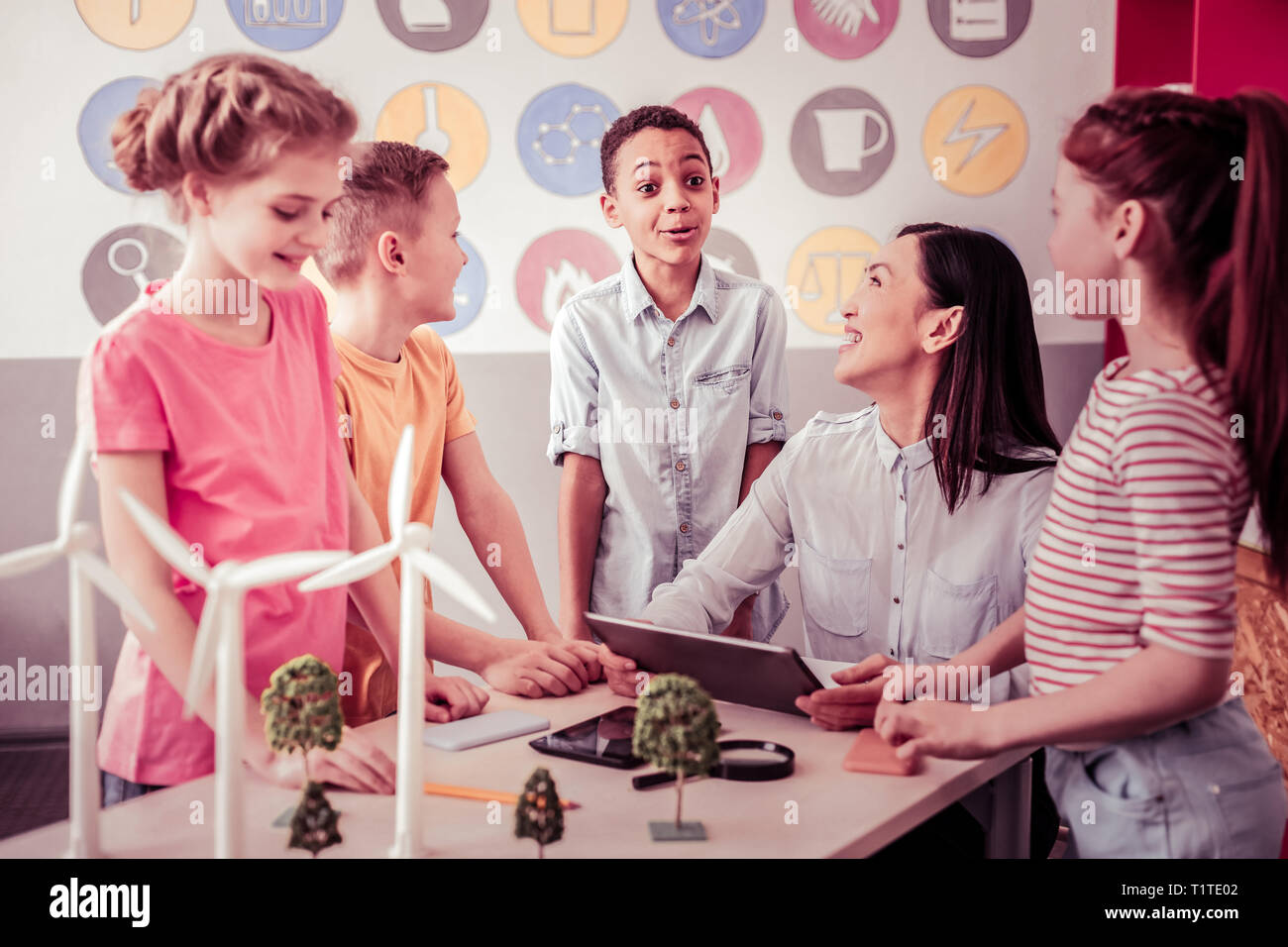 Group of students with their teacher discussing interesting situations ...