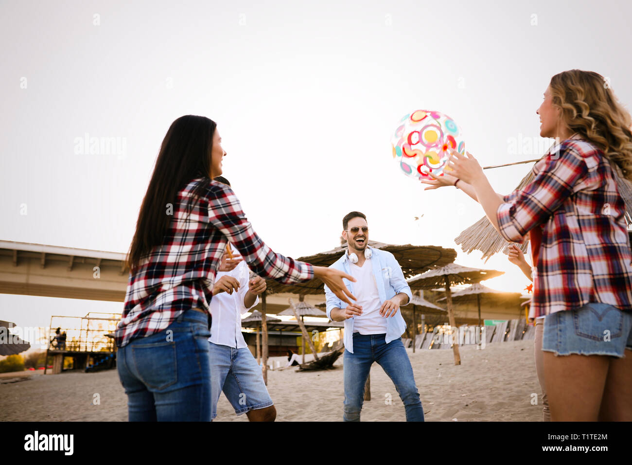 Group of happy friends partying on beach Stock Photo - Alamy
