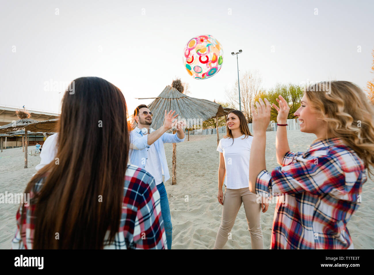 Group of happy friends partying on beach Stock Photo - Alamy