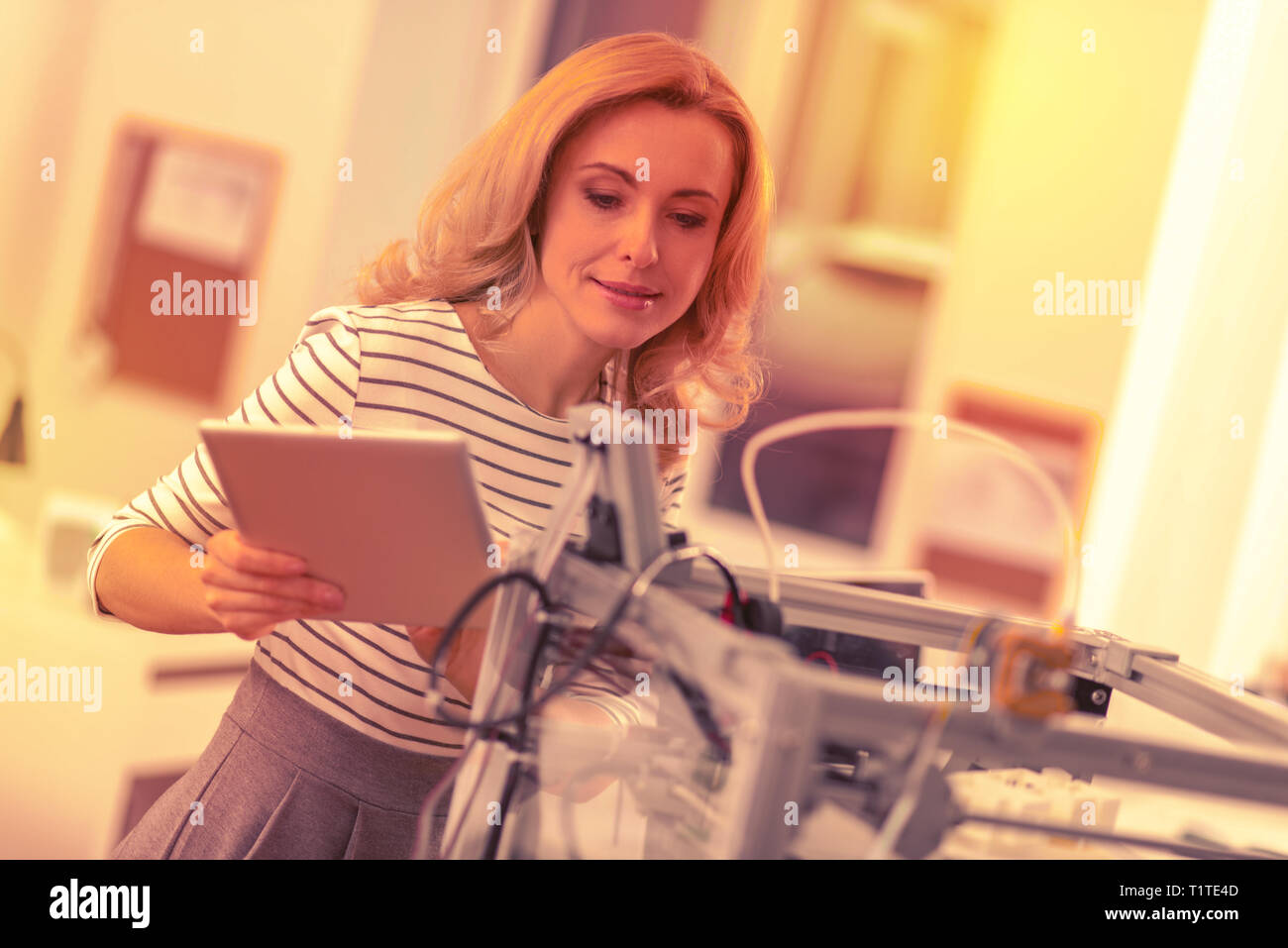 Female CEO carefully checking if everything's functioning correctly ...