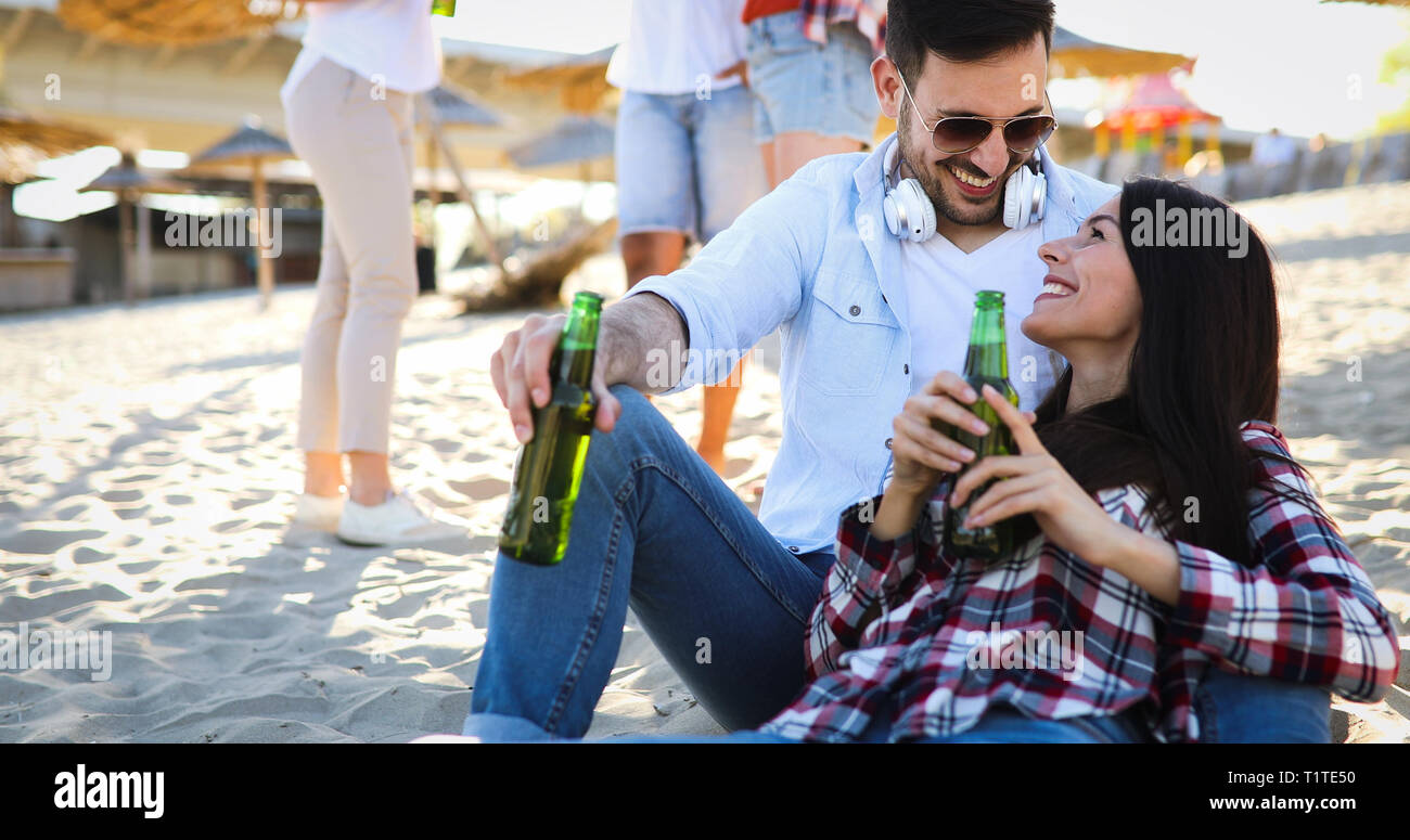 Group of happy friends partying on beach Stock Photo - Alamy
