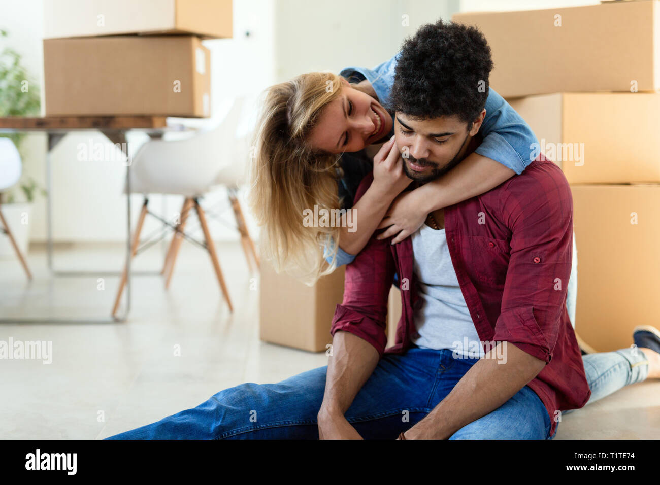 Tired couple with boxes moving into new home Stock Photo - Alamy