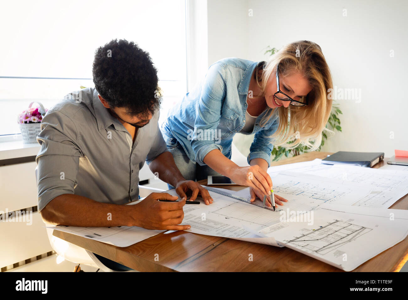 Male architects blueprint working hi-res stock photography and images ...