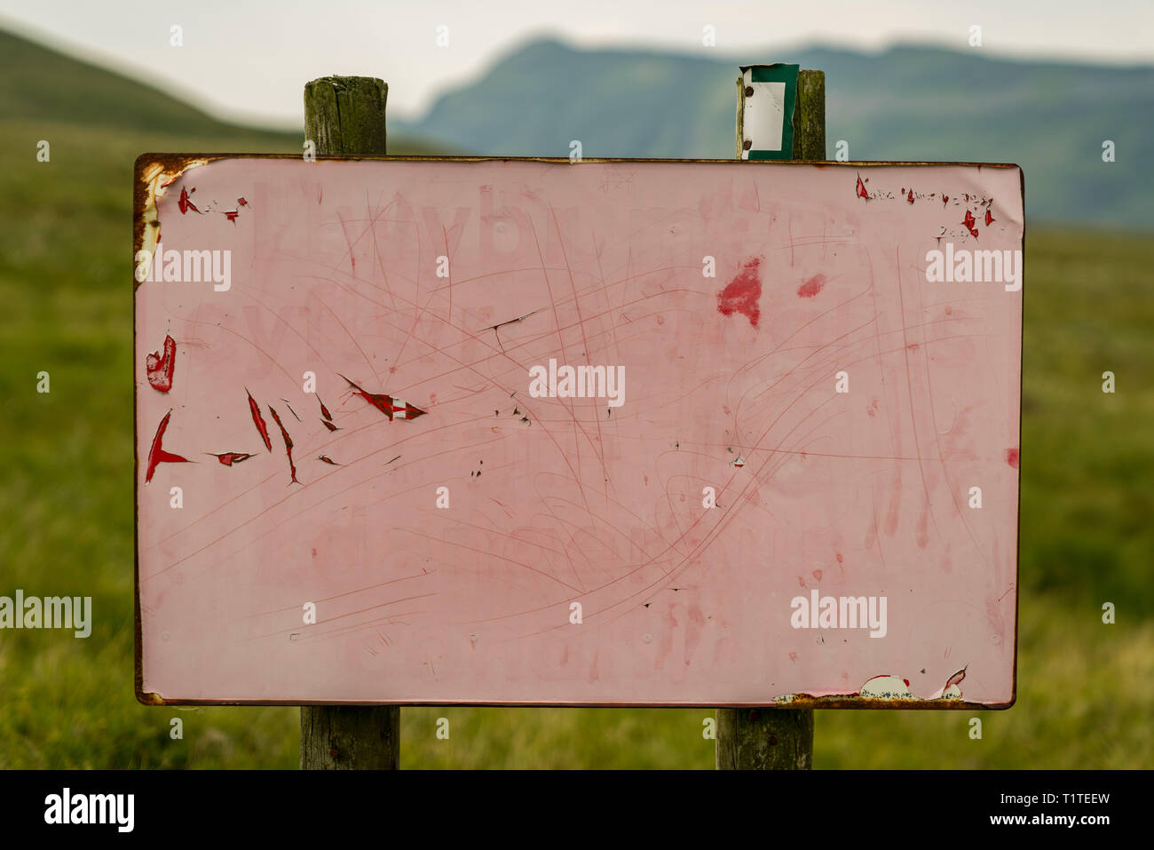 Washed out and unreadable Warning sign on top of Moel yr Hydd near ...