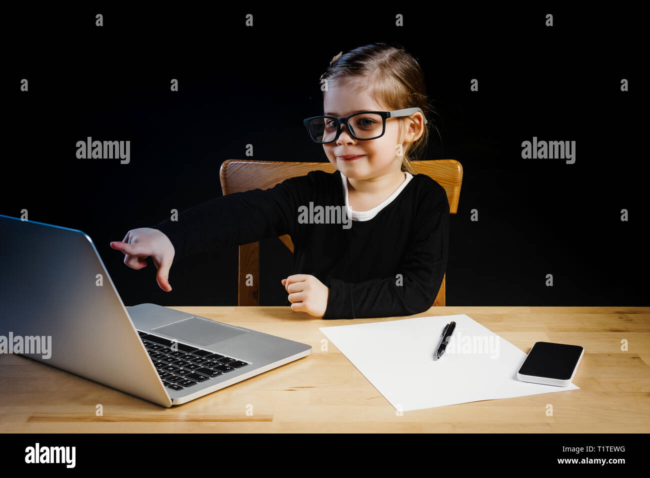 little girl shows a finger on a computer screen Stock Photo - Alamy