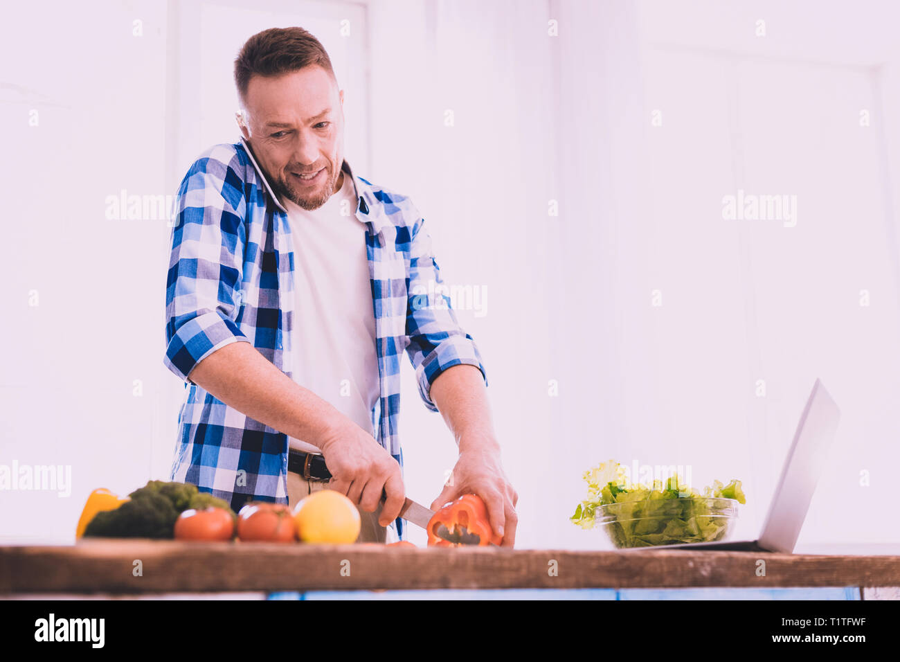 Excited man doing his best to cook something delicious Stock Photo - Alamy