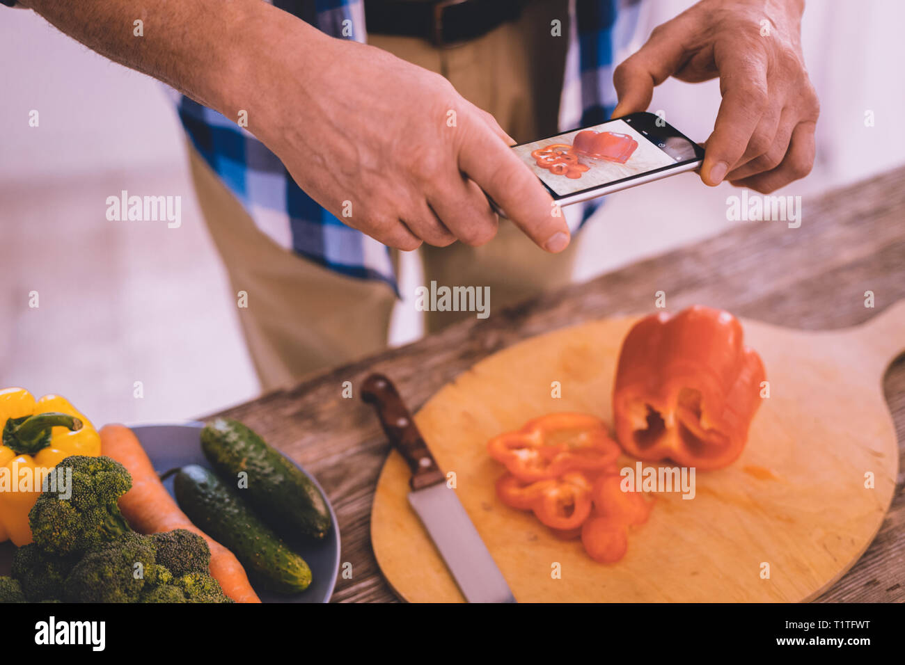 Modern man making a photo of food in the kitchen Stock Photo - Alamy