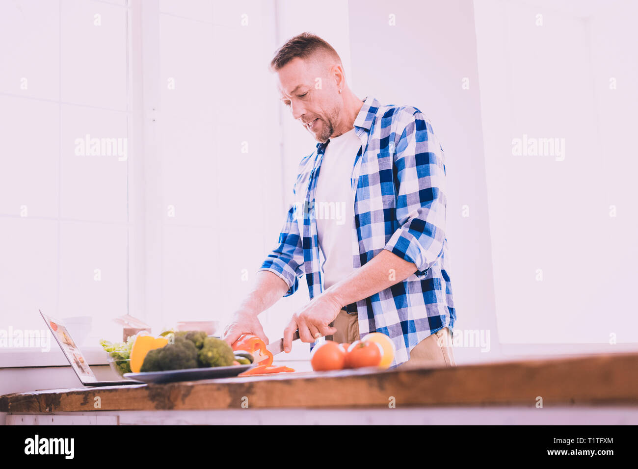 Angry man cooking alone in the kitchen Stock Photo - Alamy