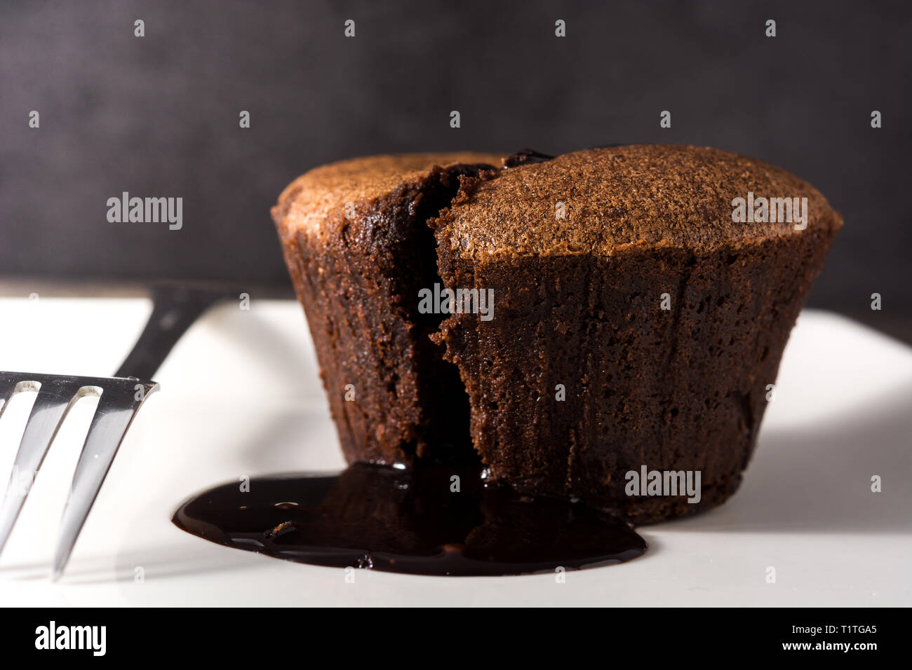 Coulant chocolate cake on wooden table Stock Photo - Alamy