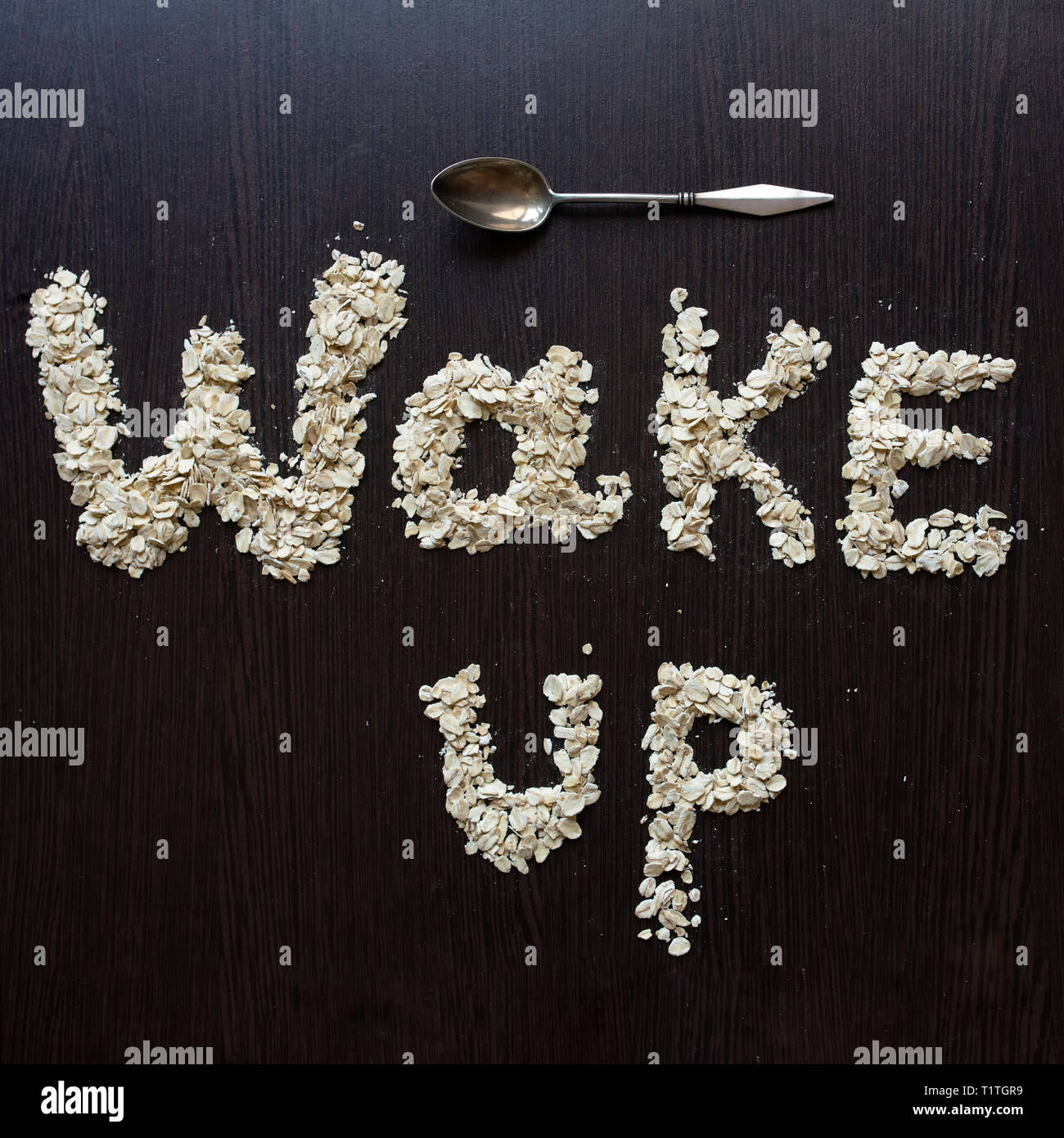letters of oatmeal lined with words Wake up on the background of a dark ...