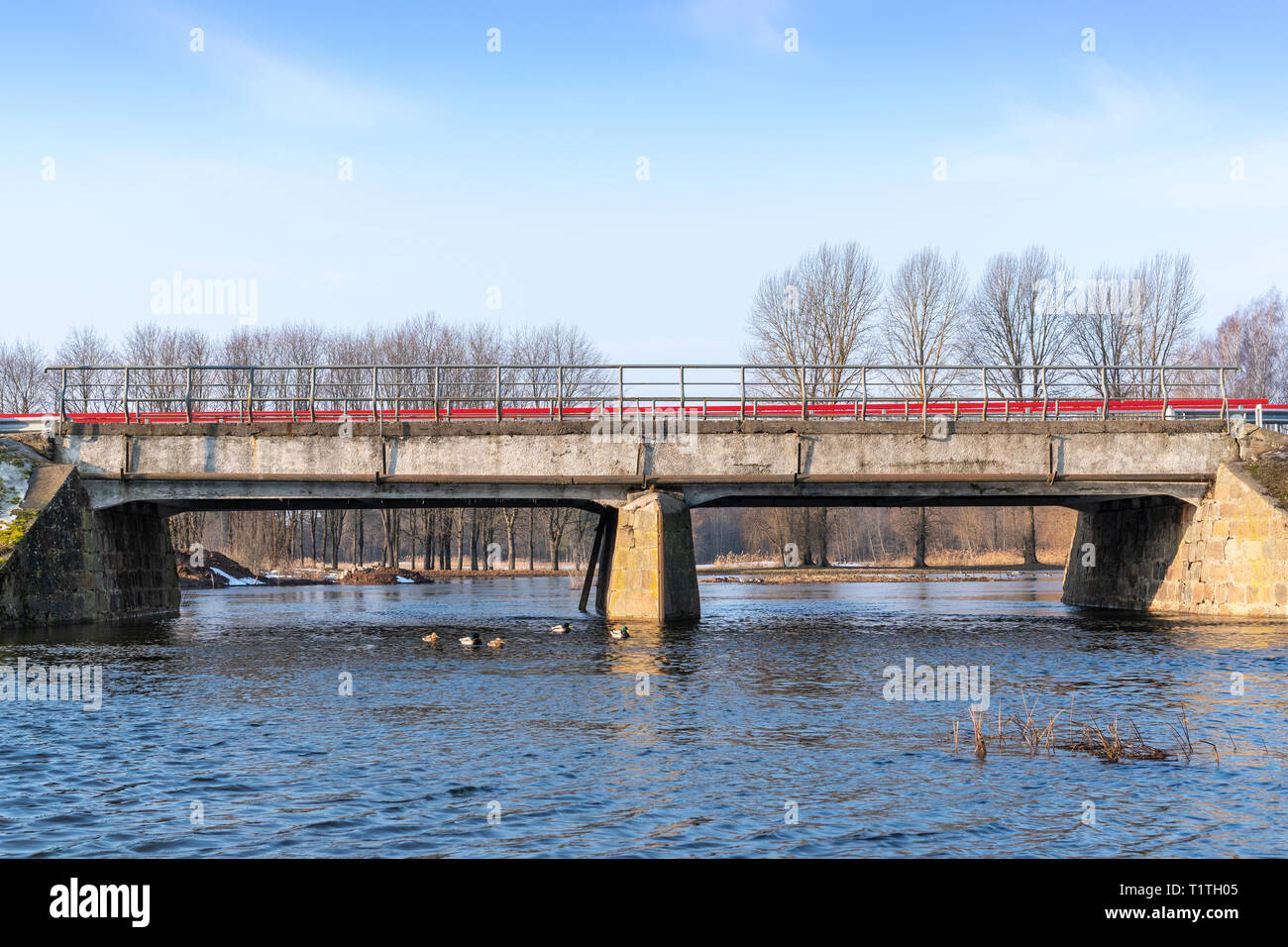 The view of the bridge across the spring river Stock Photo - Alamy