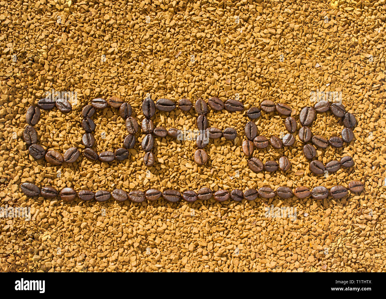the word coffee from the coffee beans on the background of scattered ...