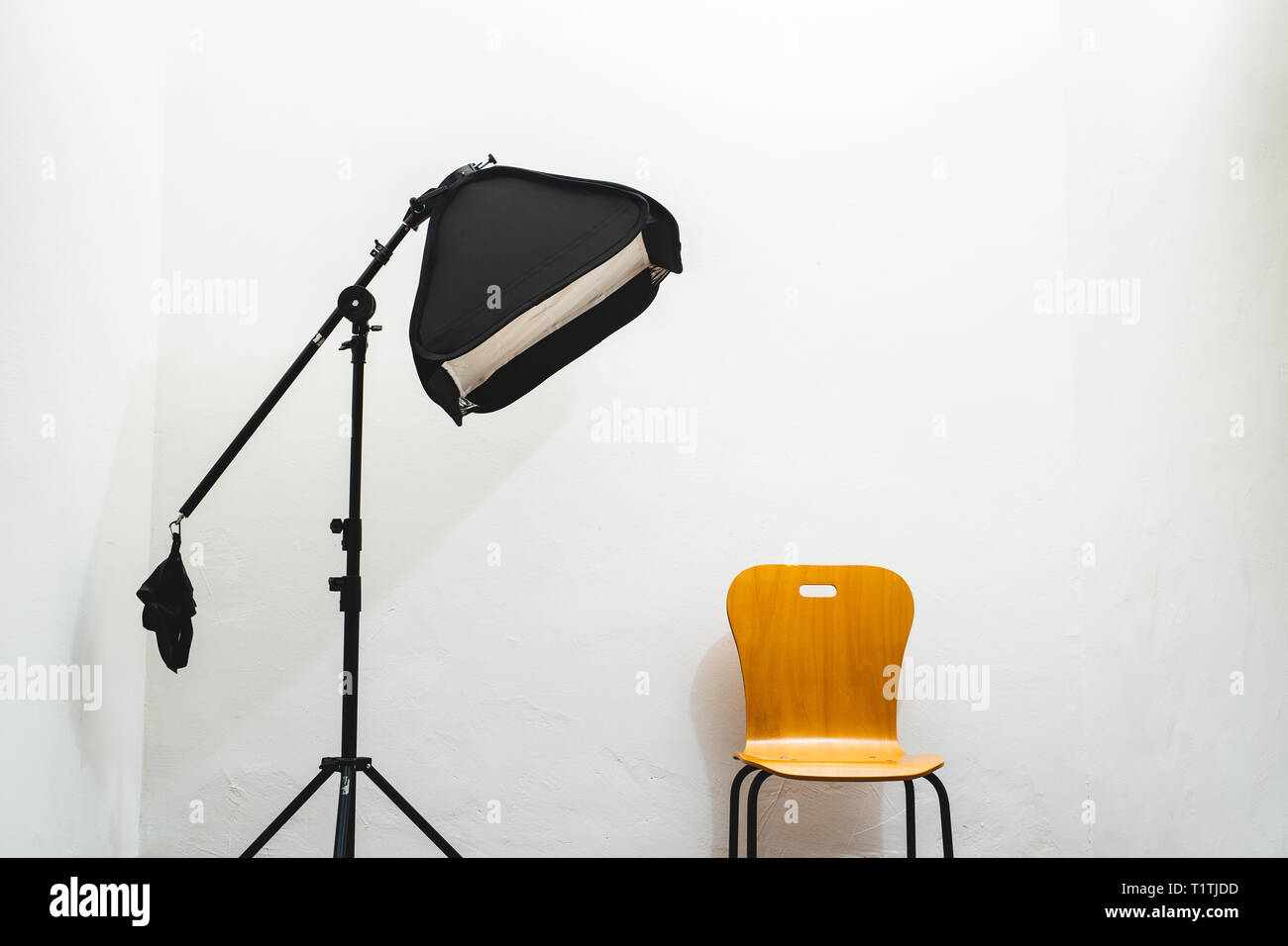 view of light stand softbox and chair isolated Stock Photo - Alamy