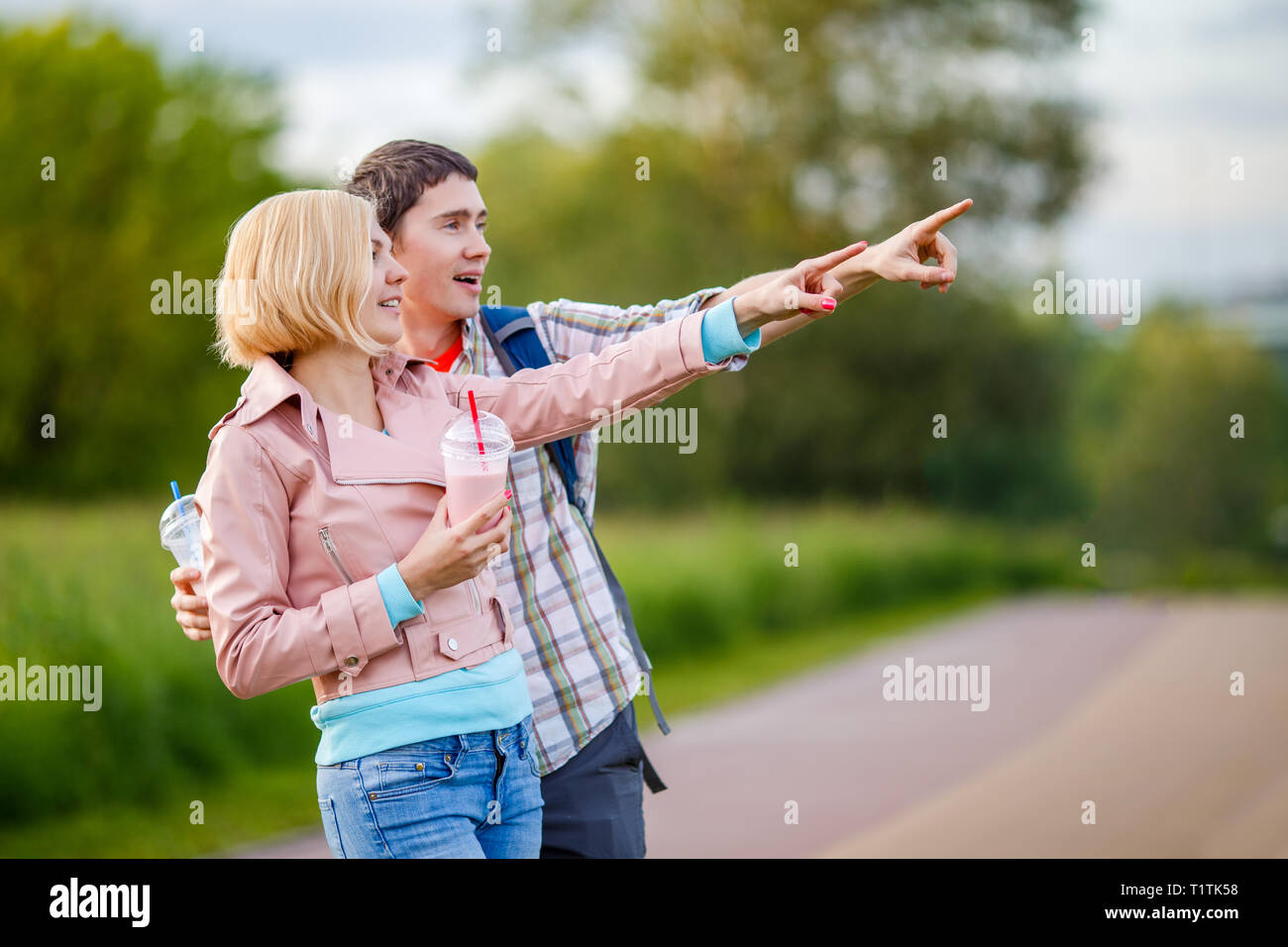 Pair showing hand in distance Stock Photo - Alamy