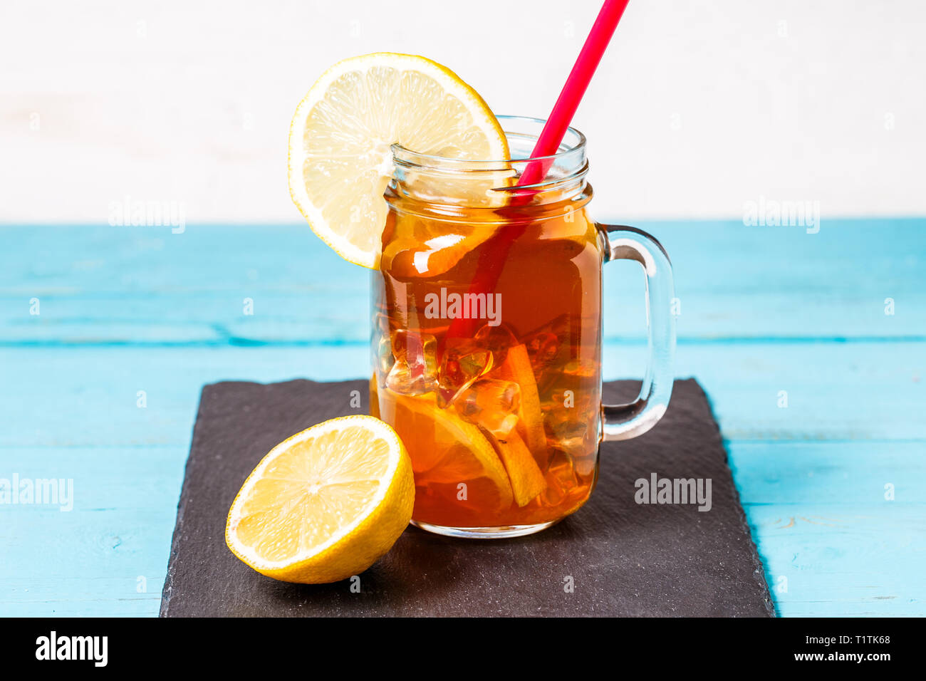 Iced tea in a glass jar with lemon Stock Photo - Alamy