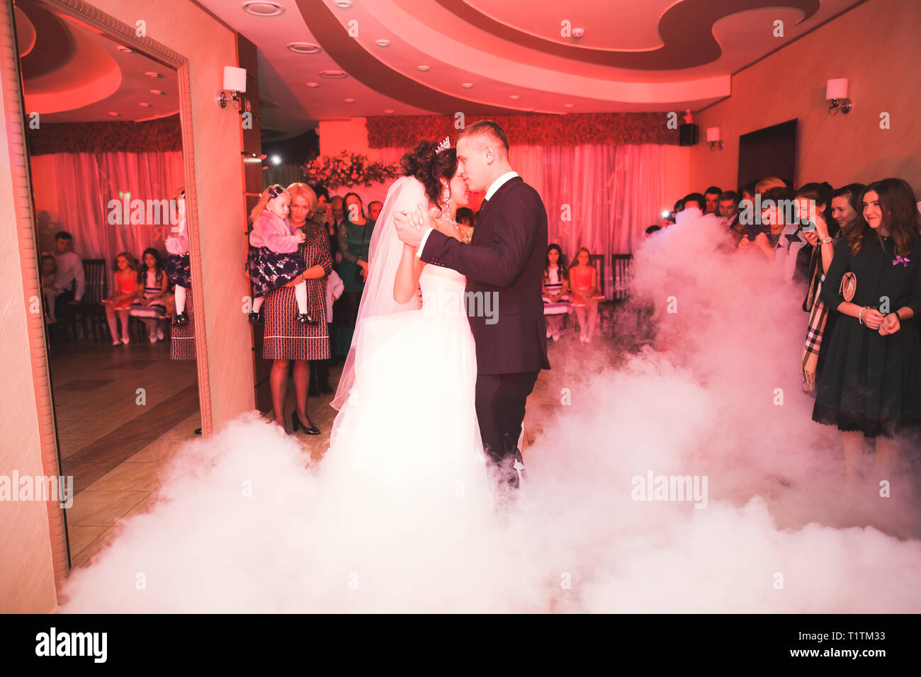 Beautiful wedding couple just married and dancing their first dance ...