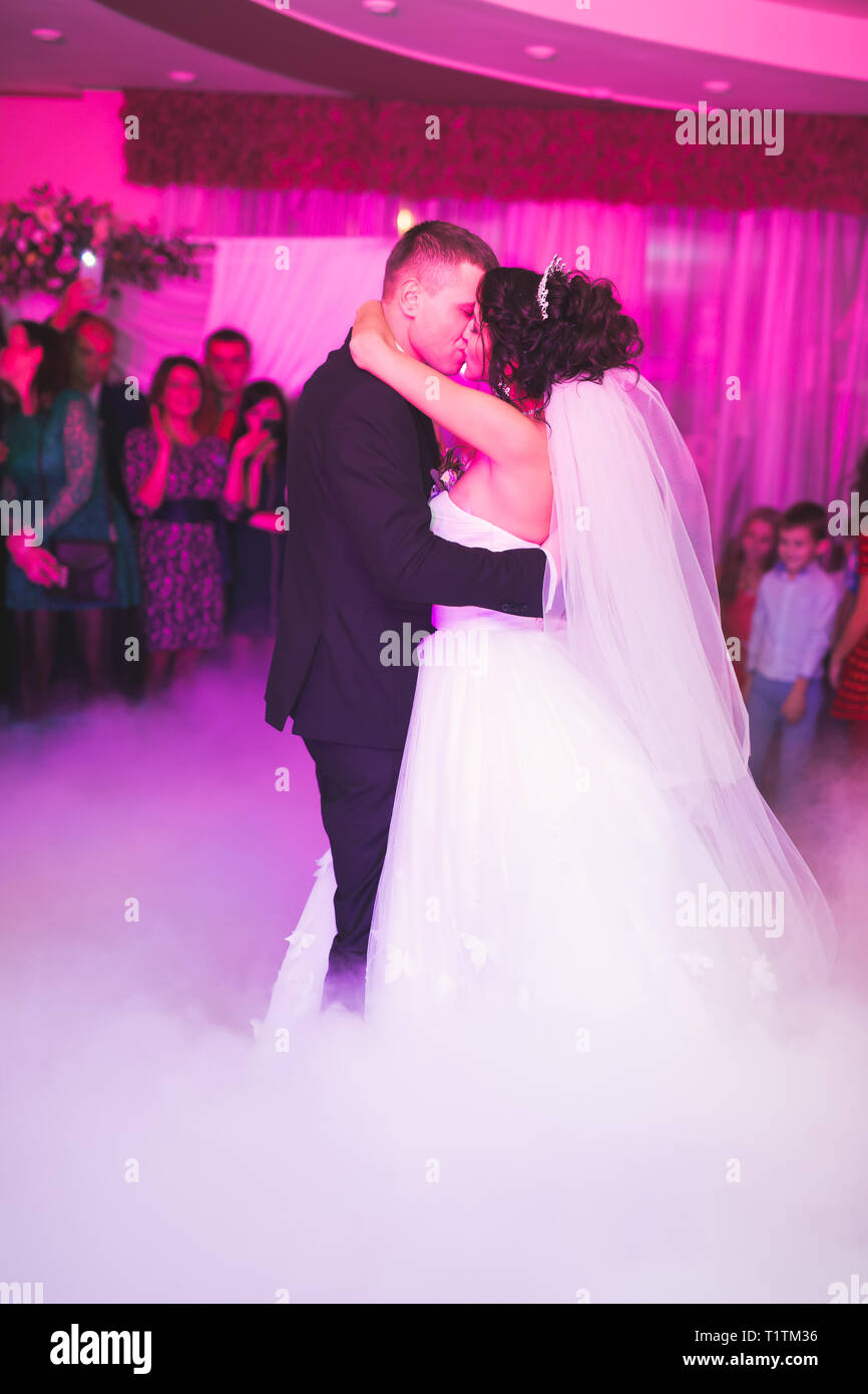 Beautiful wedding couple just married and dancing their first dance ...
