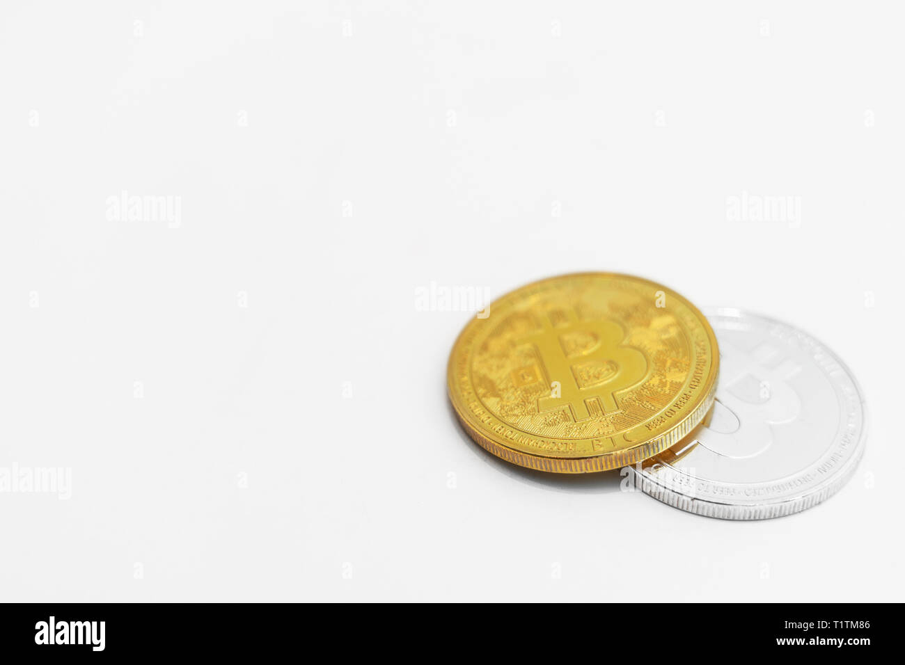 Physical version of silver and golden bitcoins on white background ...