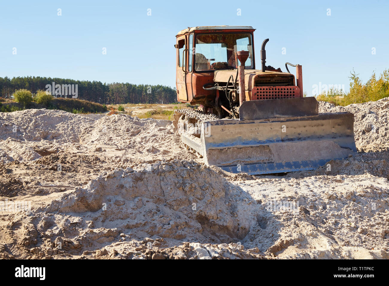 Sand quarry. Bulldozer working on sand dunes. Pure lake sand. Old sand ...