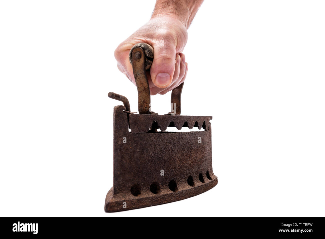 Hand strongly holding an antique and rusty iron from coal ironing with ...