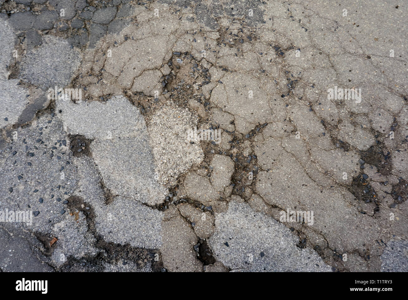 destructed tar road in a town Stock Photo - Alamy