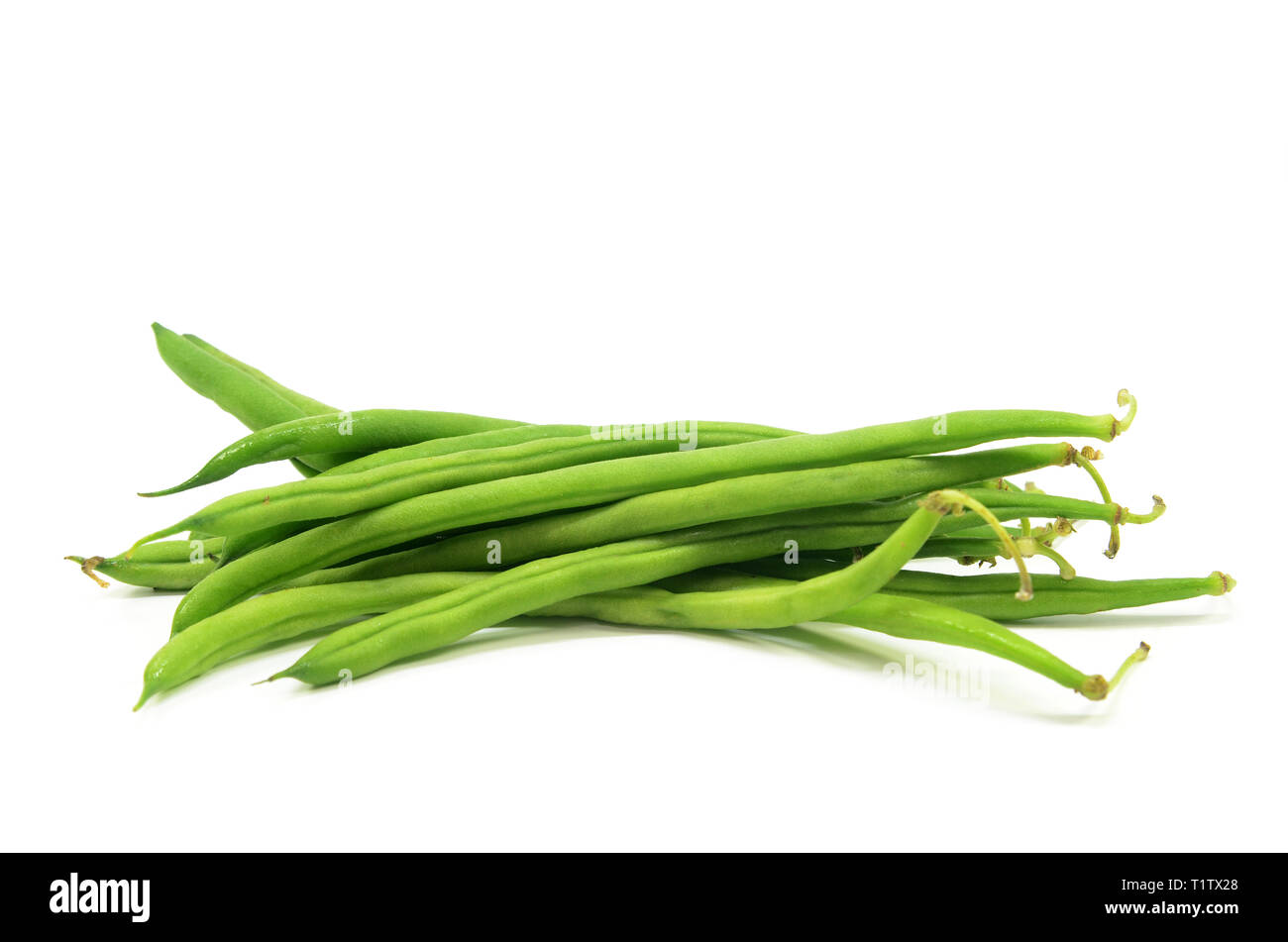 Pile of raw green baby fine beans on a white background Stock Photo - Alamy