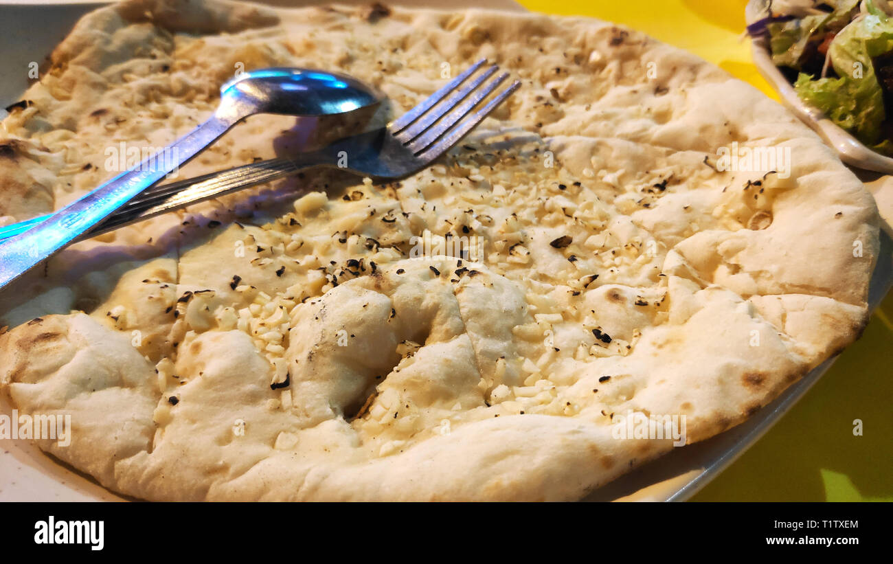 Garlic naan on a plate. Indian food Stock Photo - Alamy