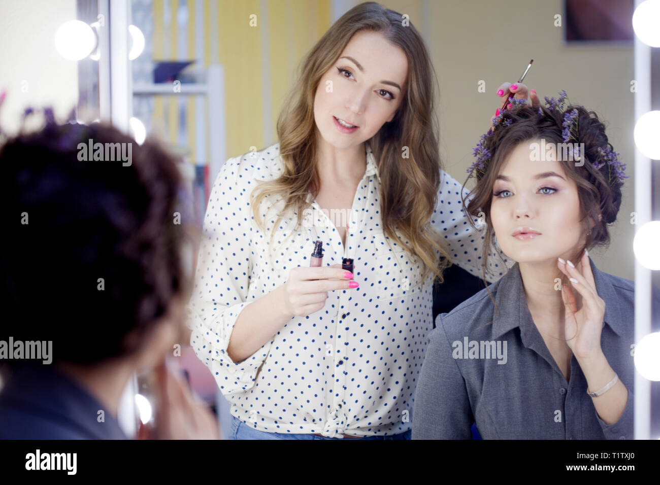 Stylist makeup artist doing makeup and hair in a beauty salon ...