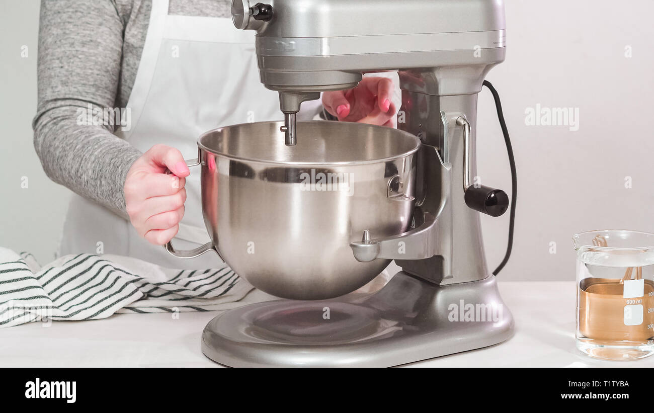 Step by step. Flat lay. Mixing royal icing in electric kitchen mixer ...