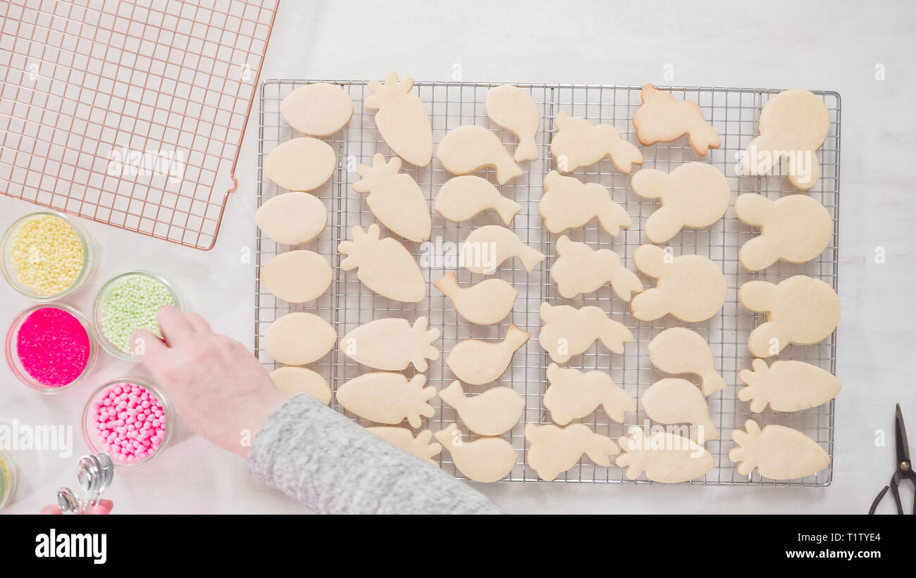 Step by step. Flat lay. Decorating Easter sugar cookies with rotal ...