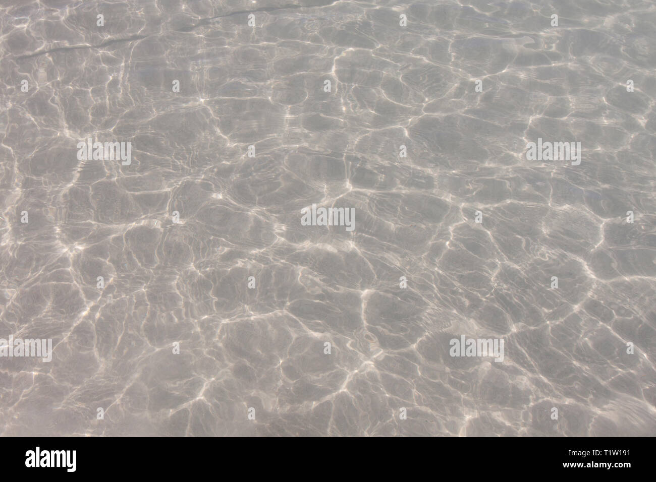 Clear water surface with white sand Stock Photo - Alamy
