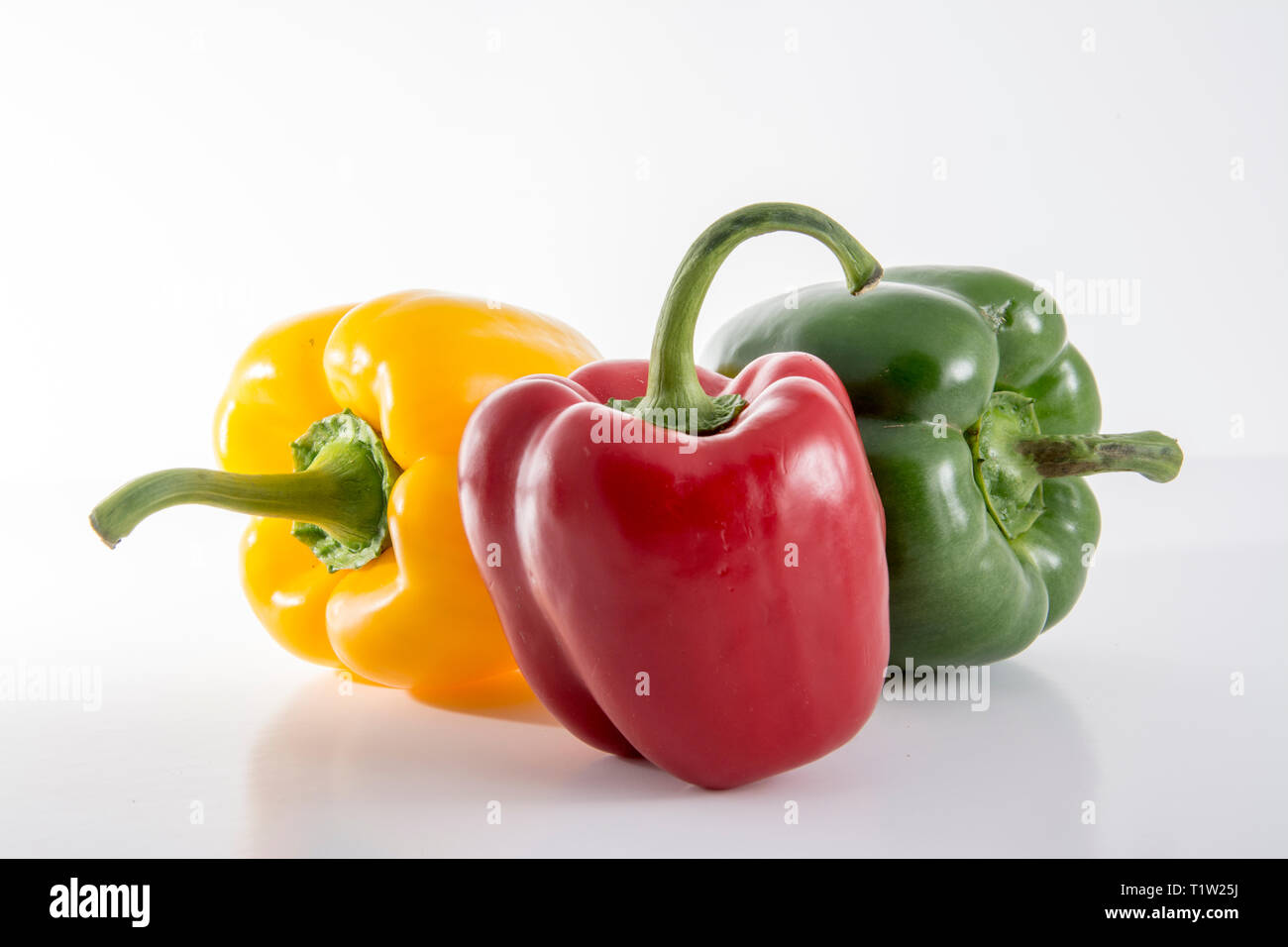 Red, green and yellow British peppers on white background Stock Photo ...