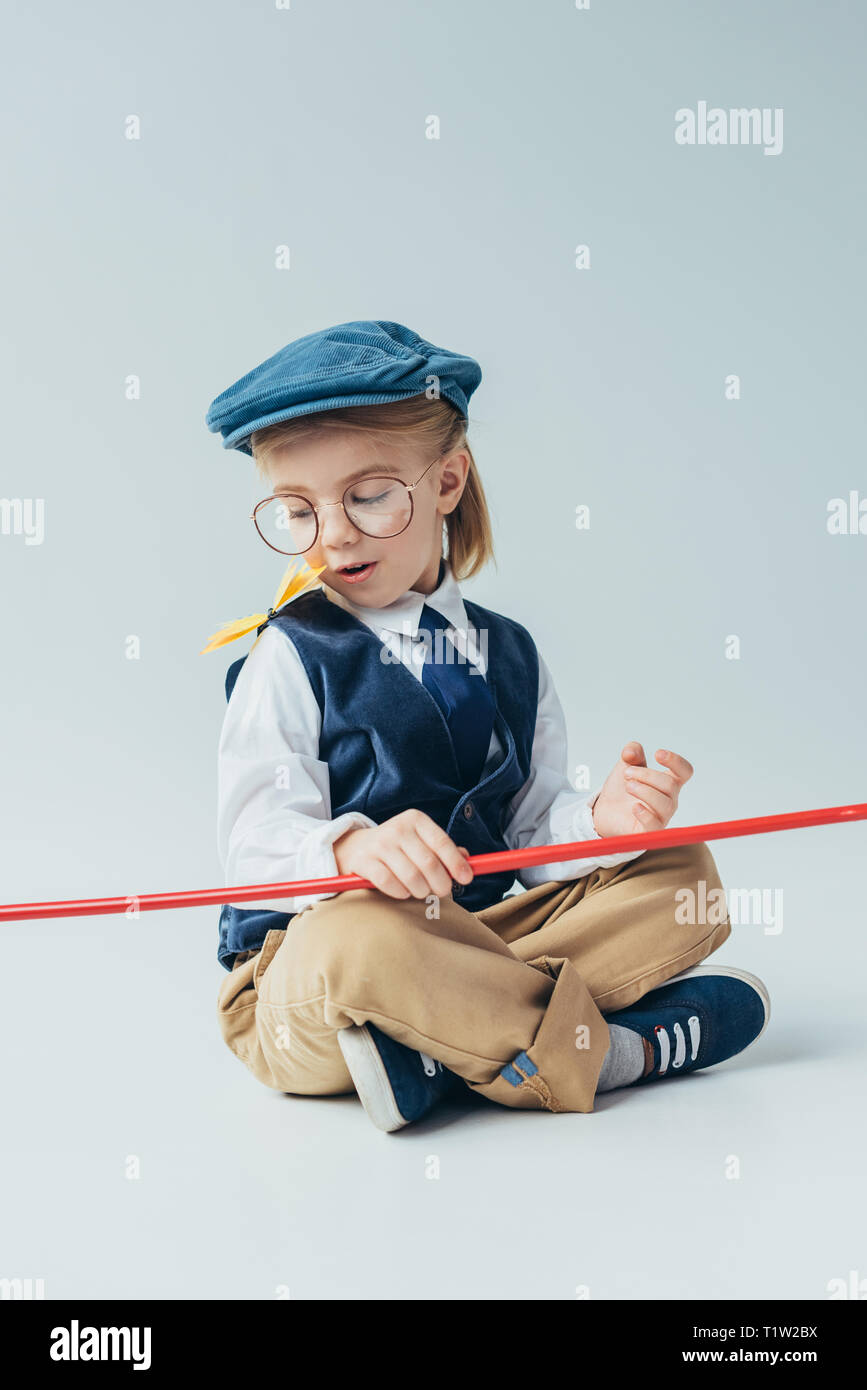 surprised kid sitting with crossed legs and looking at butterfly Stock ...