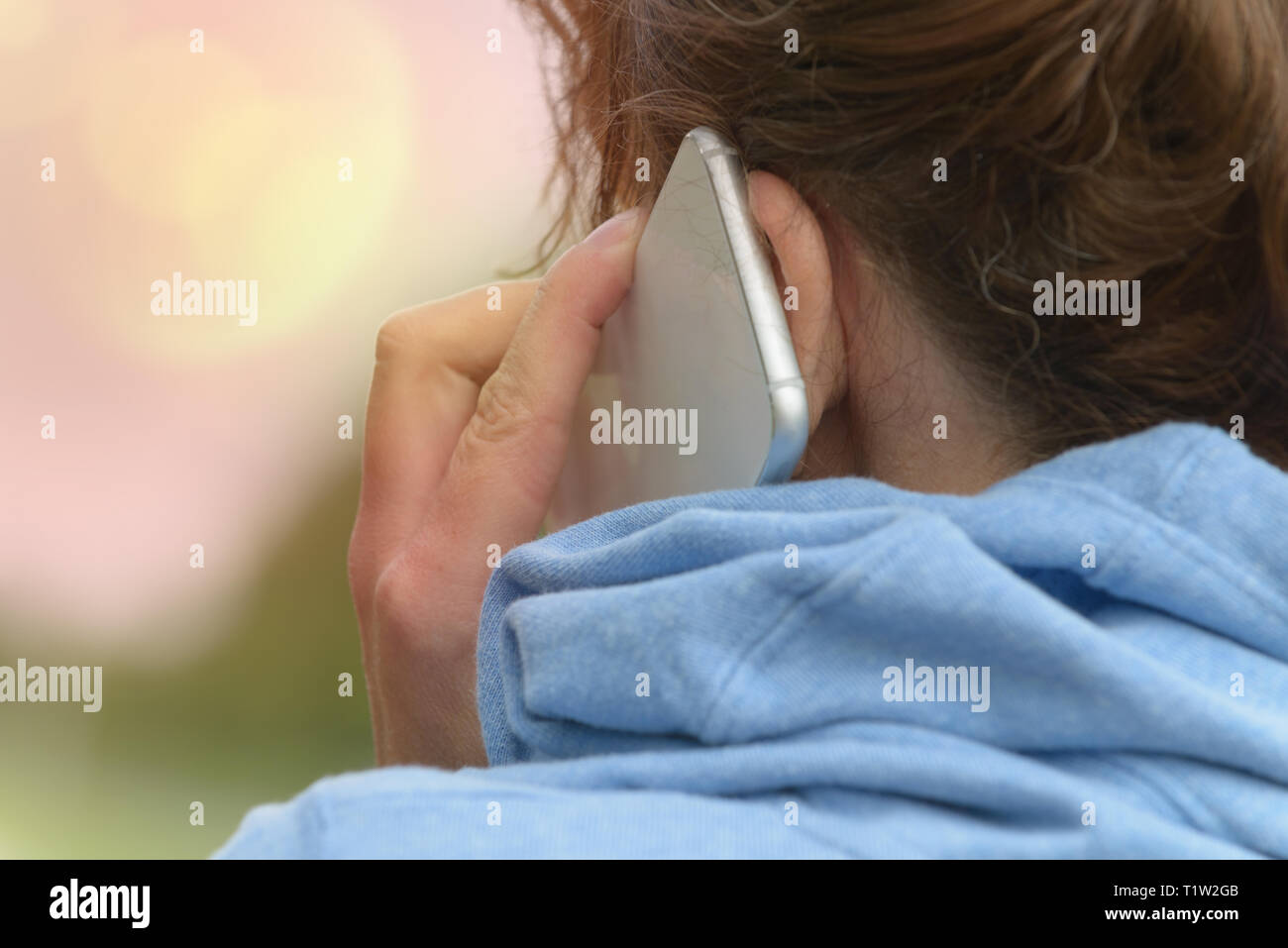 Woman talking on mobile phone, back view Stock Photo - Alamy